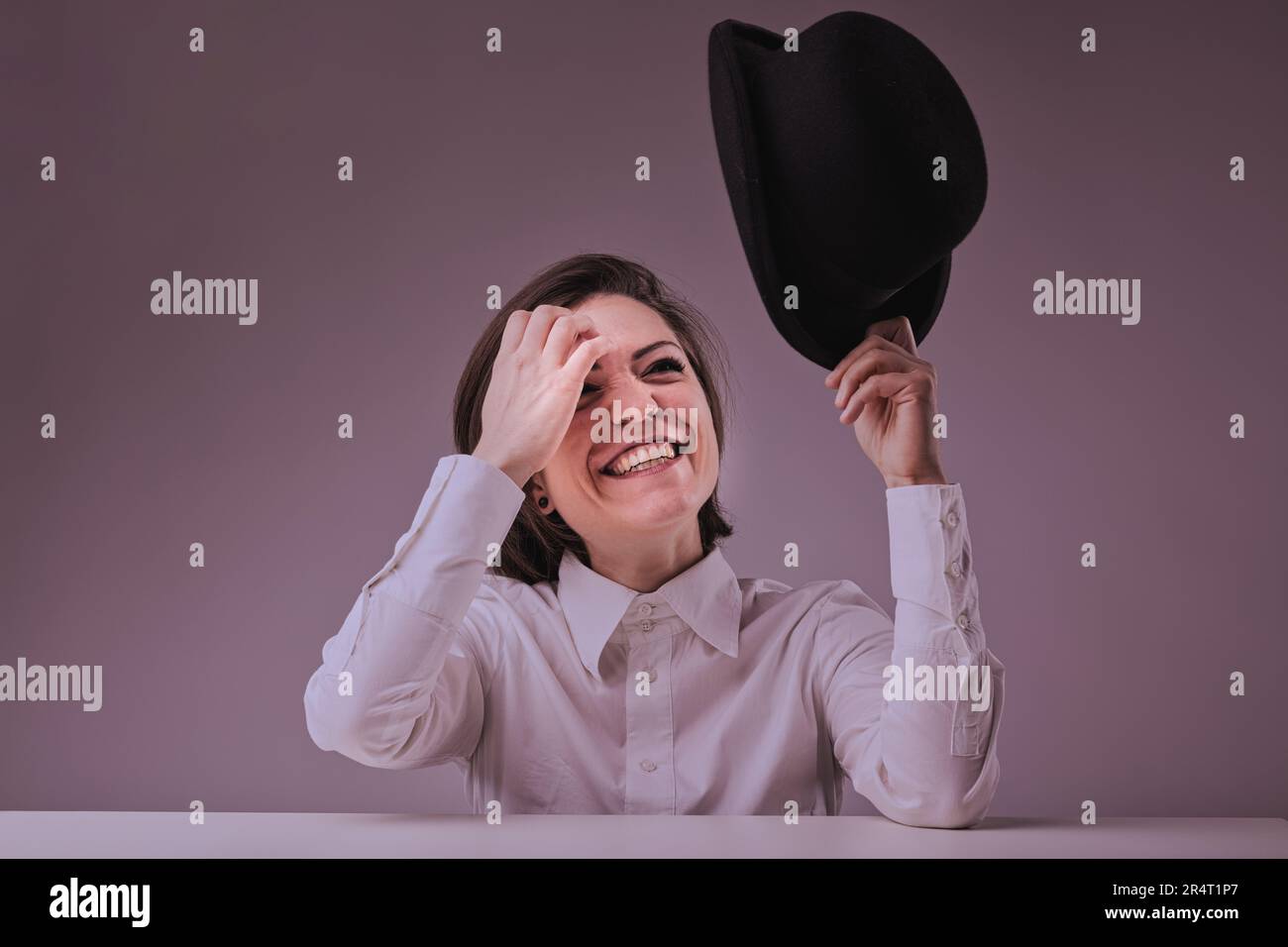 Woman chuckles, feeling complicit and awkward, as she scratches her ...