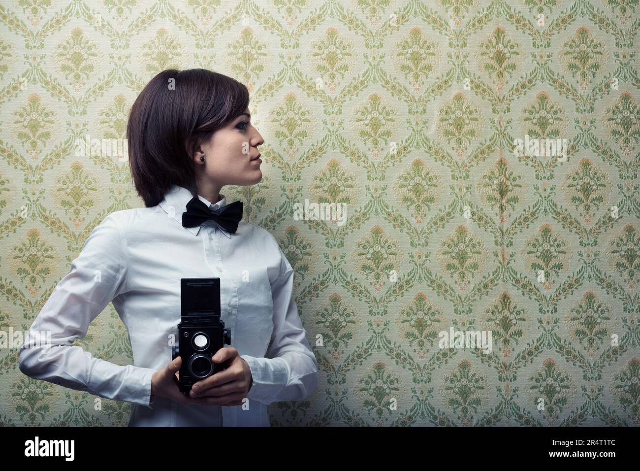 Professional woman with a twin-lens reflex film camera, in white shirt ...