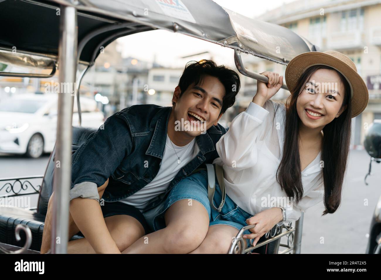 Happy and joyful Young Asian couple traveler tourists riding a tuk tuk ...