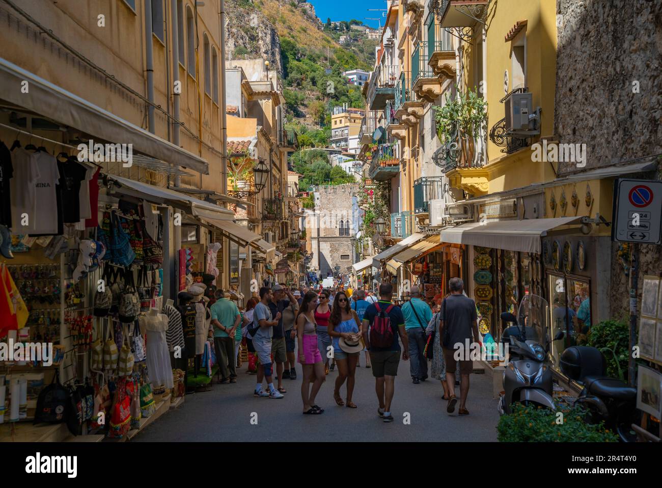 View of busy street and escalating hillside in background in Taormina ...