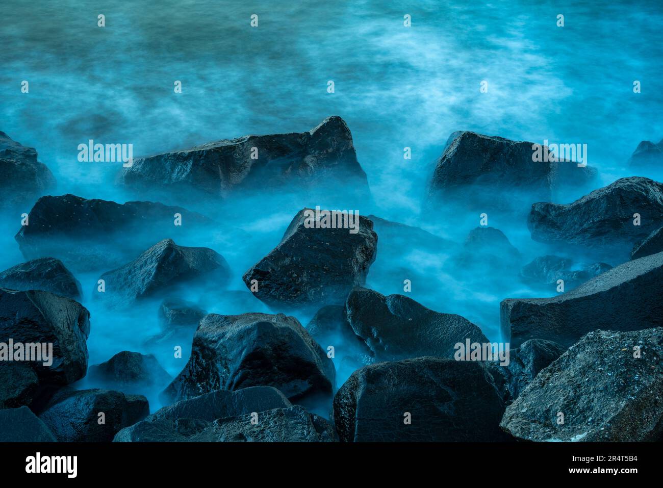 View of mist effect of waves over stones on beach in Giardini Naxos ...
