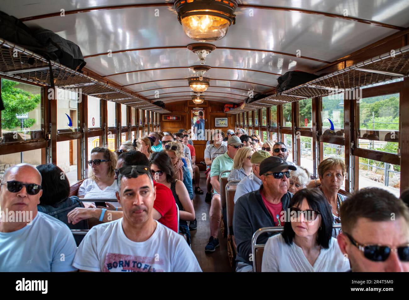 Tourists inside of tren de Soller train vintage historic train that ...