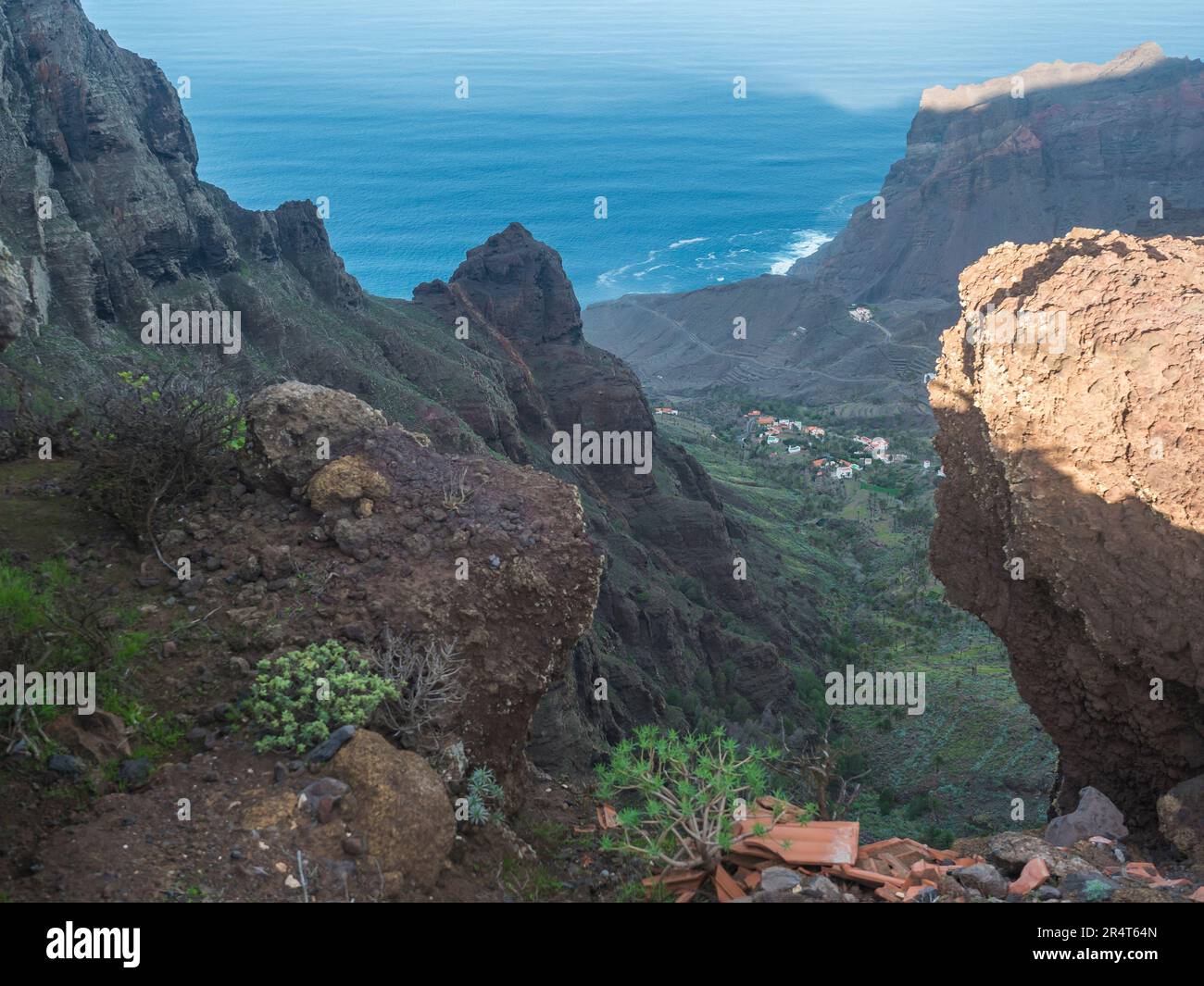 Aerial view of village Taguluche in green valley with palm trees, cacti ...
