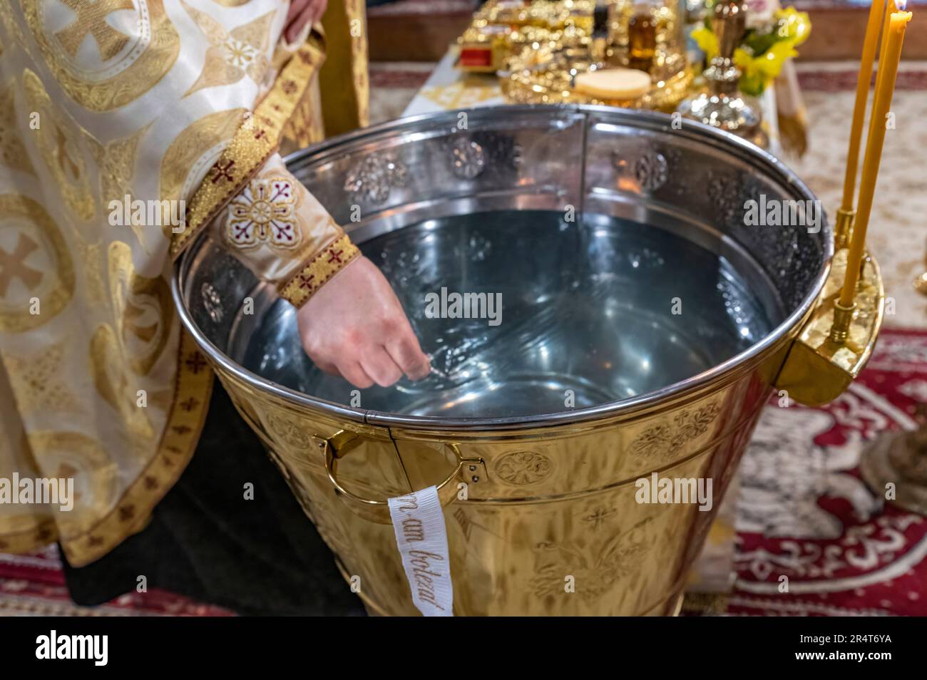 baptismal font with water for the Orthodox baptism in the church, with the priest Stock Photo ...
