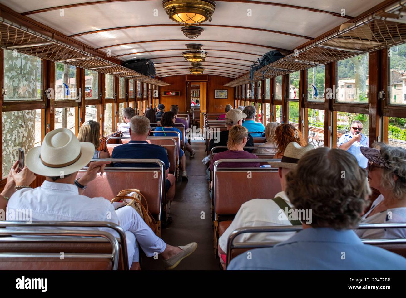 Tourists inside of tren de Soller train vintage historic train that ...
