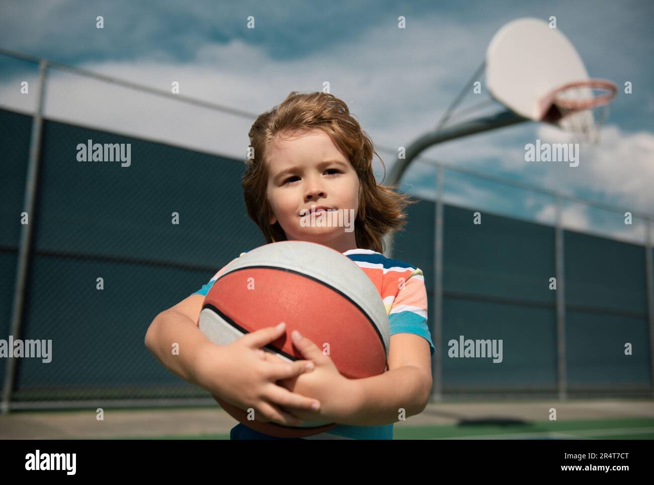 Kid playing basketball. Child boy preparing for basketball shooting ...