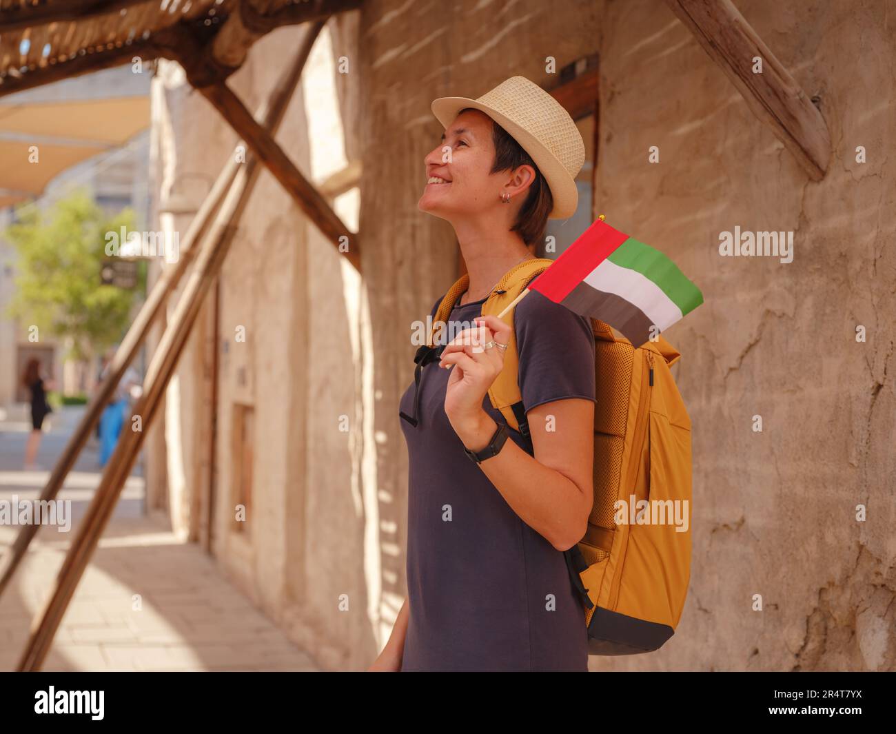 tourist trip to old Dubai, UAE. Asian Woman tourist holding UAE flag in ...