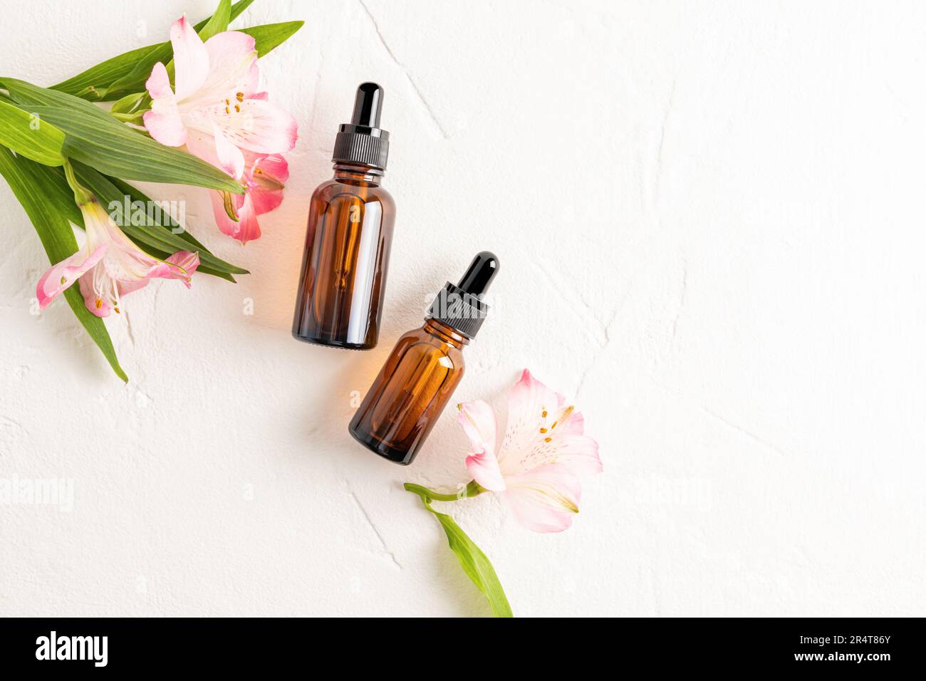 Top view of two pipette bottles of natural organic self-care ...