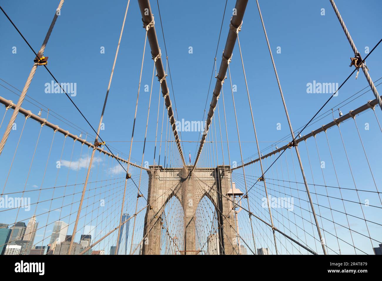 US, New York, Brooklyn Bridge walkway with Pylon and cables and US Flag ...