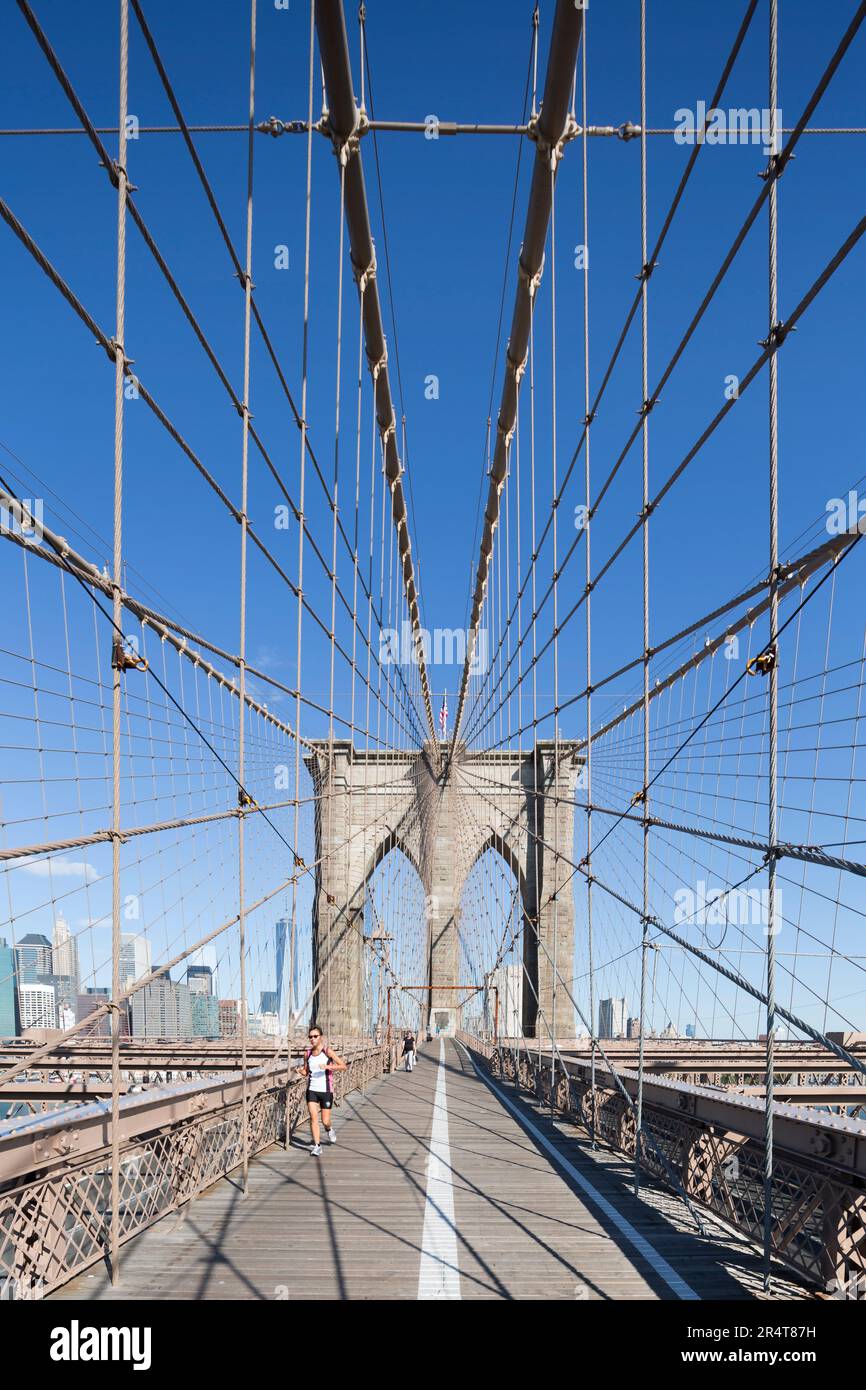 US, New York, Brooklyn Bridge walkway with Pylon and cables and US Flag ...