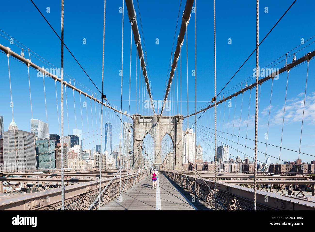 US, New York, Brooklyn Bridge walkway with Pylon and cables and US Flag ...
