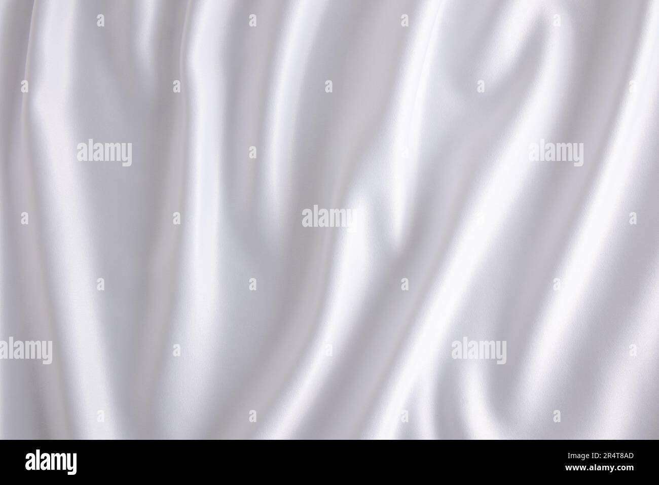 Luxurious wedding textiles. satin white delicate background. soft folds of satin fabric ...