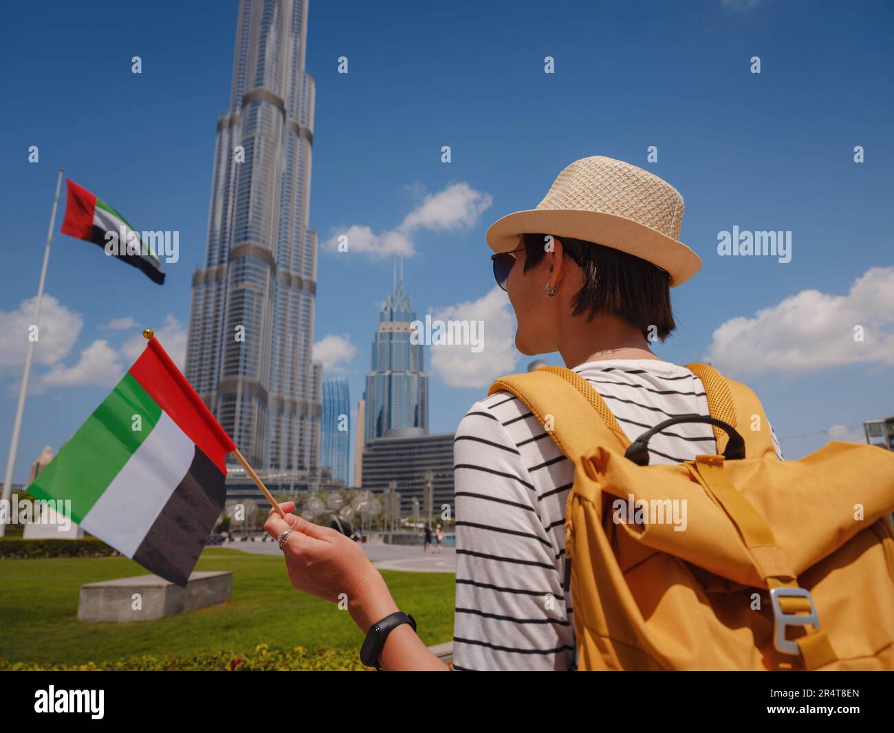 Enjoying travel in United Arabian Emirates. Young woman with yellow ...