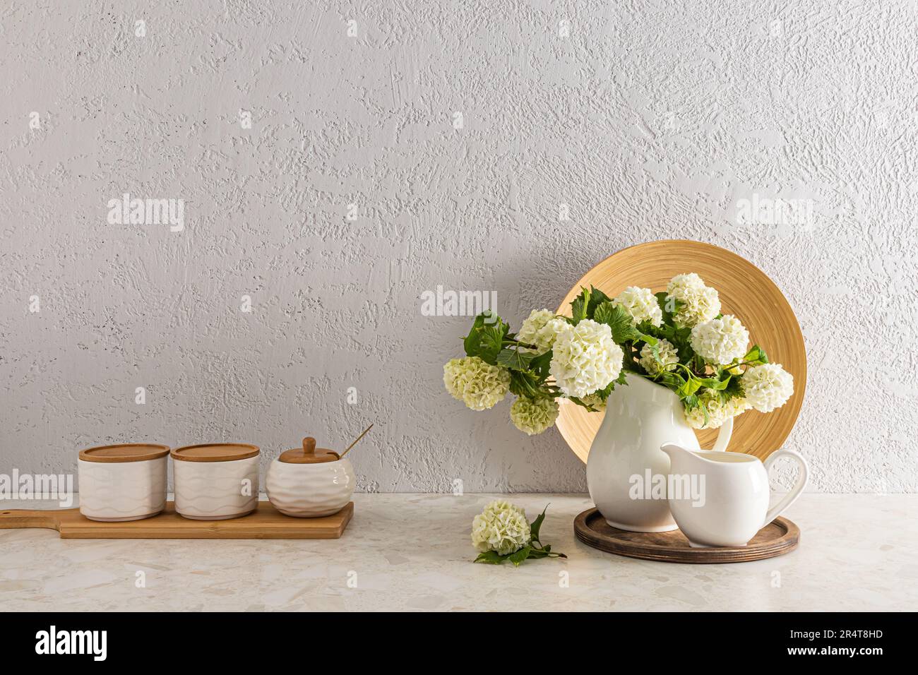 Modern kitchen countertop interior with ceramic jars and a jug with ...