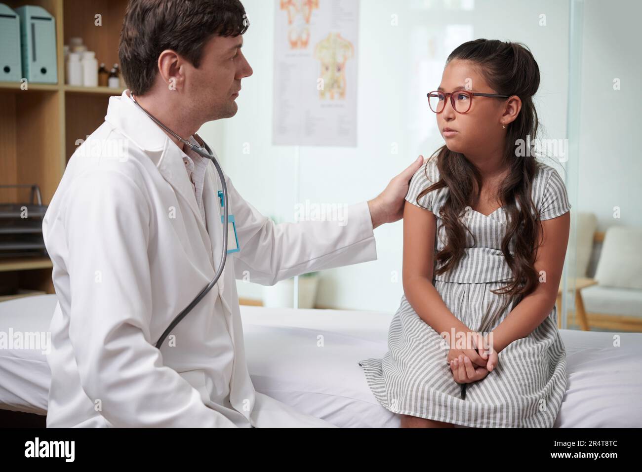 Doctor reassuring worried sick girl after examination Stock Photo - Alamy