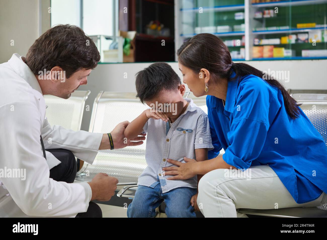 Mother and pediatrician comforting crying scared little boy Stock Photo ...