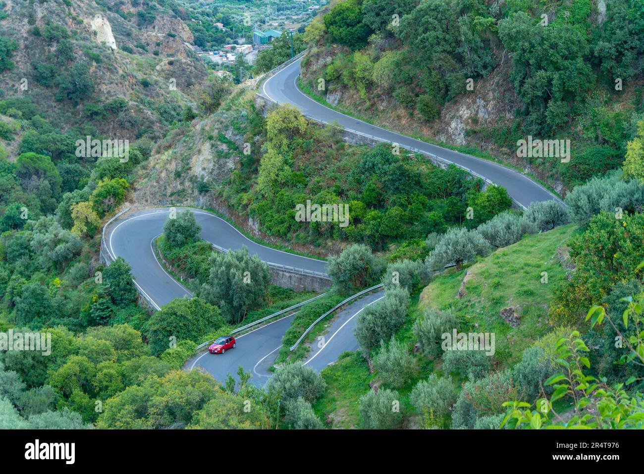 View of winding road leading to town of Savoca at sunset, Savoca ...