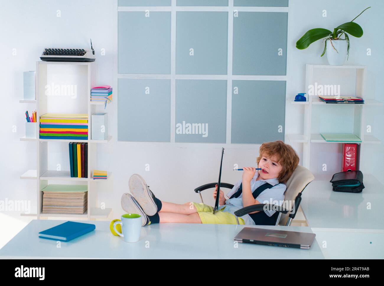 Little kid boy businessman who rules his company remotely, like a ...