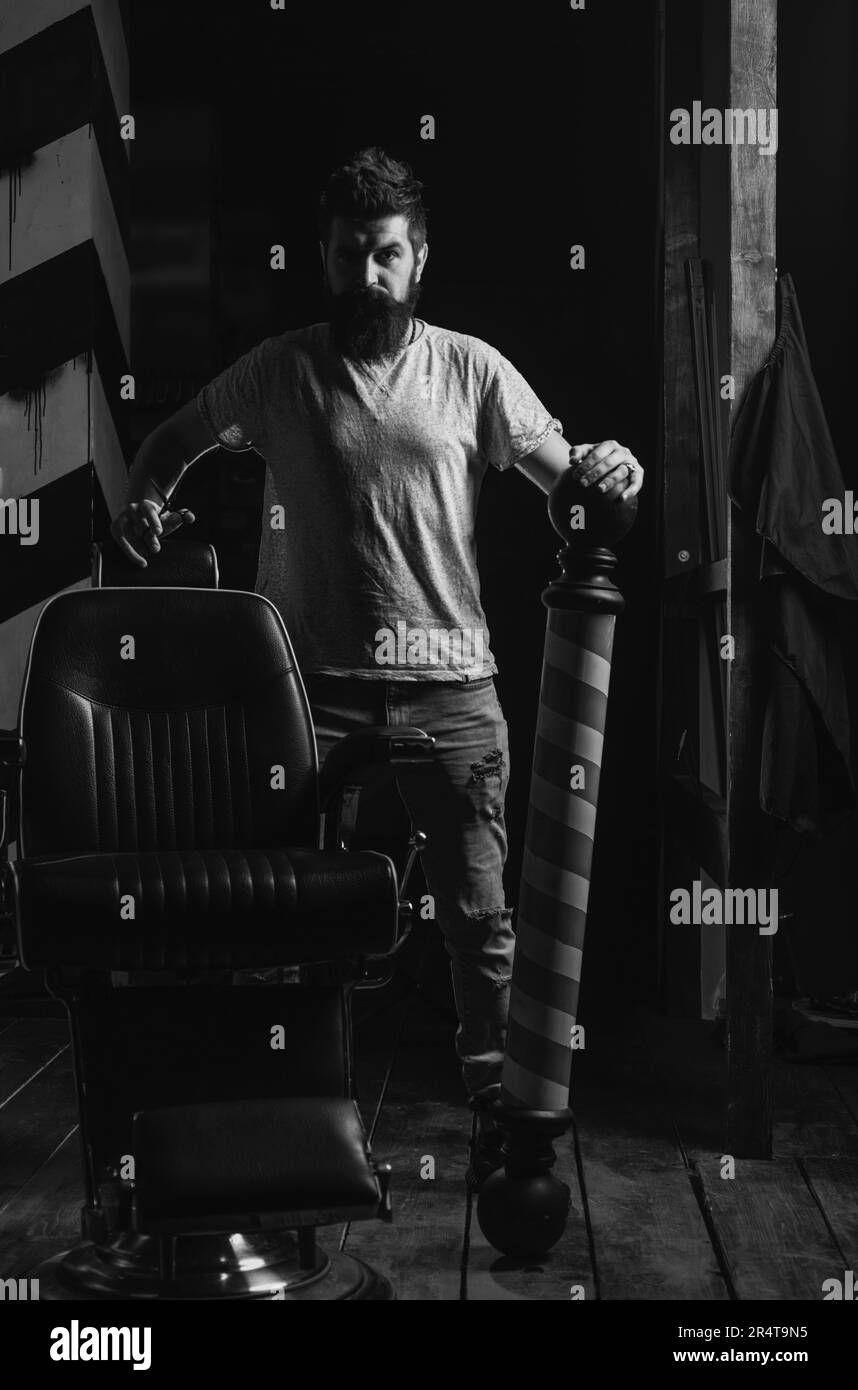 Beard man visiting hairstylist in barber shop. Brutal guy in modern ...