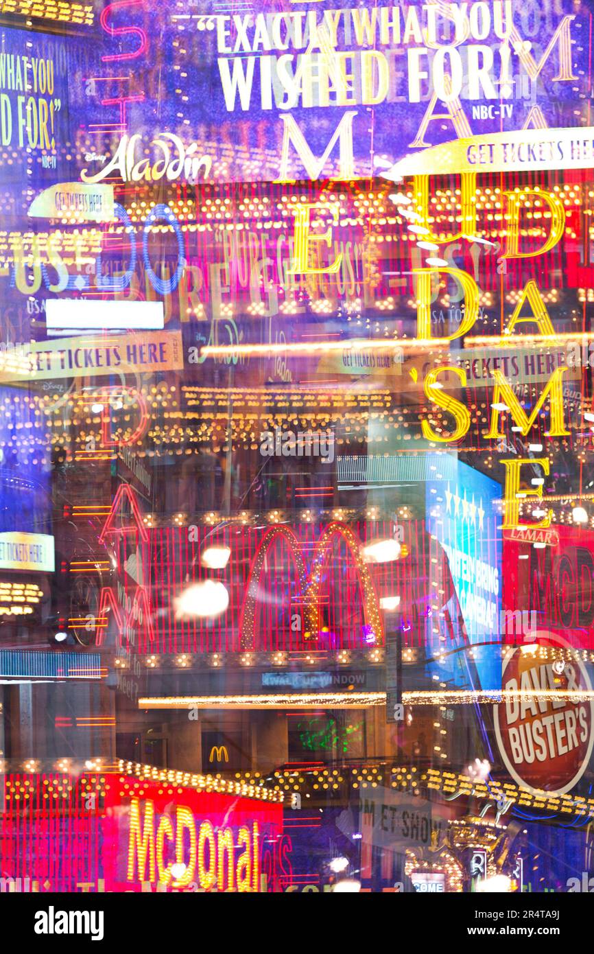 US, New York, Neon street signs around Times Square with reflections ...