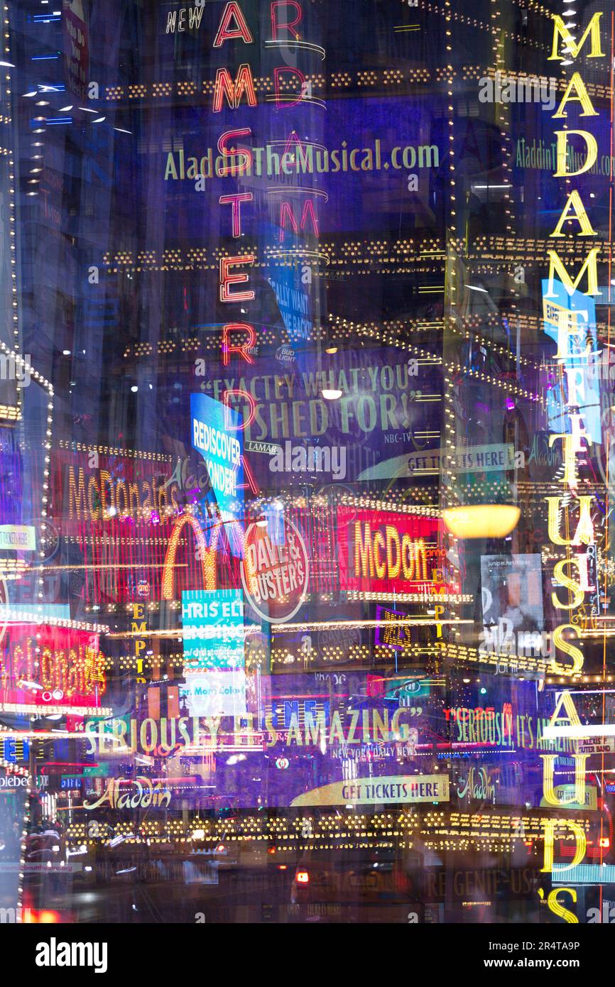 US, New York, Neon street signs around Times Square with reflections ...