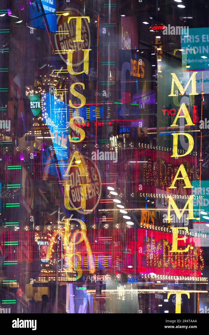 US, New York, Neon street signs around Times Square with reflections ...