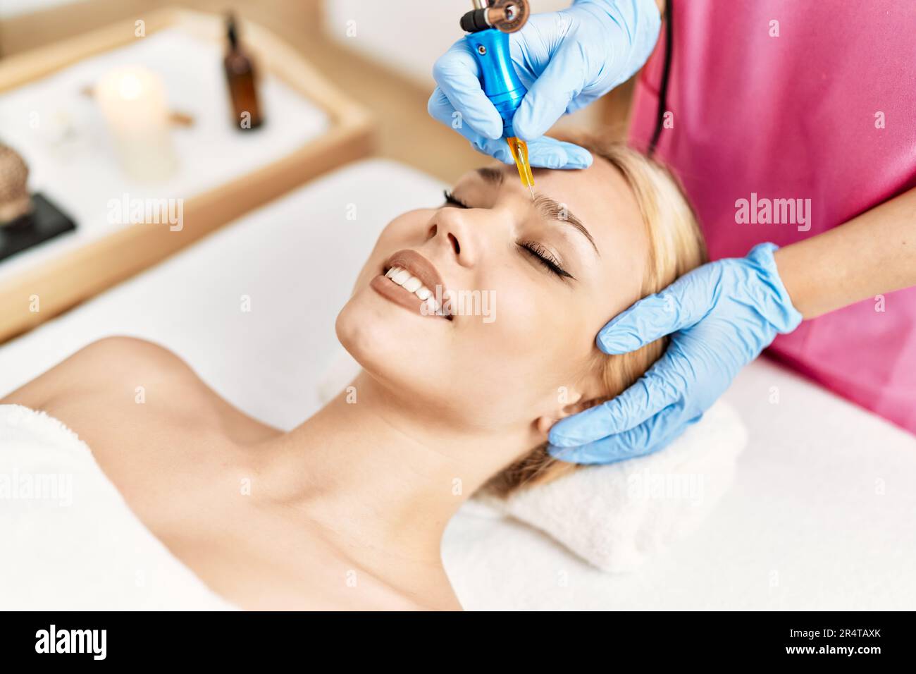 Young caucasian woman lying on table having microblading treatment at ...