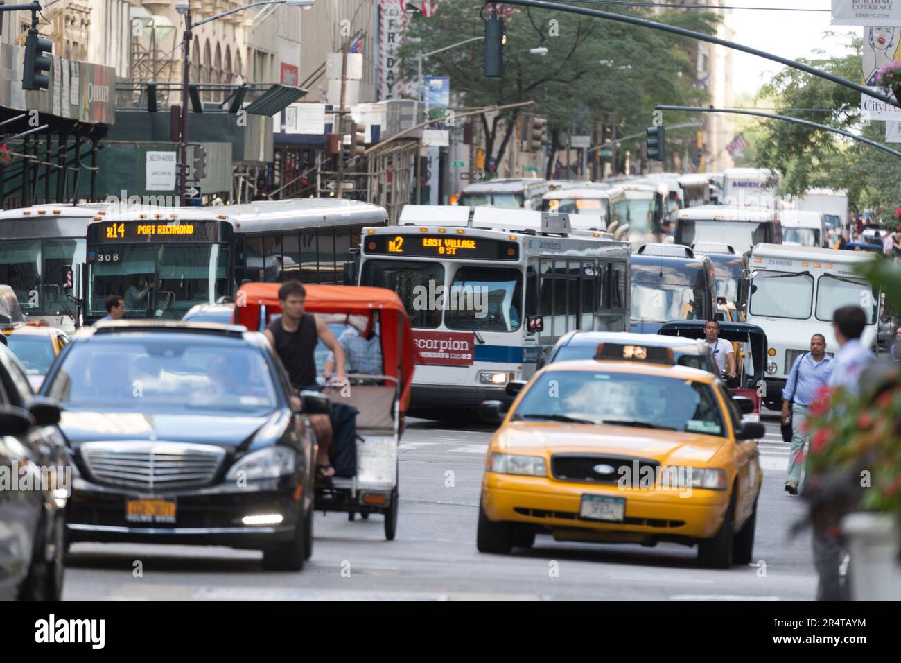 US, New York, street scene along 5th Avenue cyclists and cars Stock ...