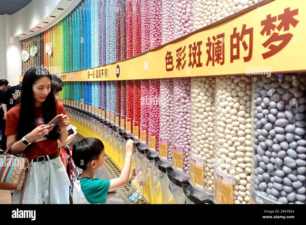 People shop at the M&M's Flagship Store in Shanghai, China, 27 May ...