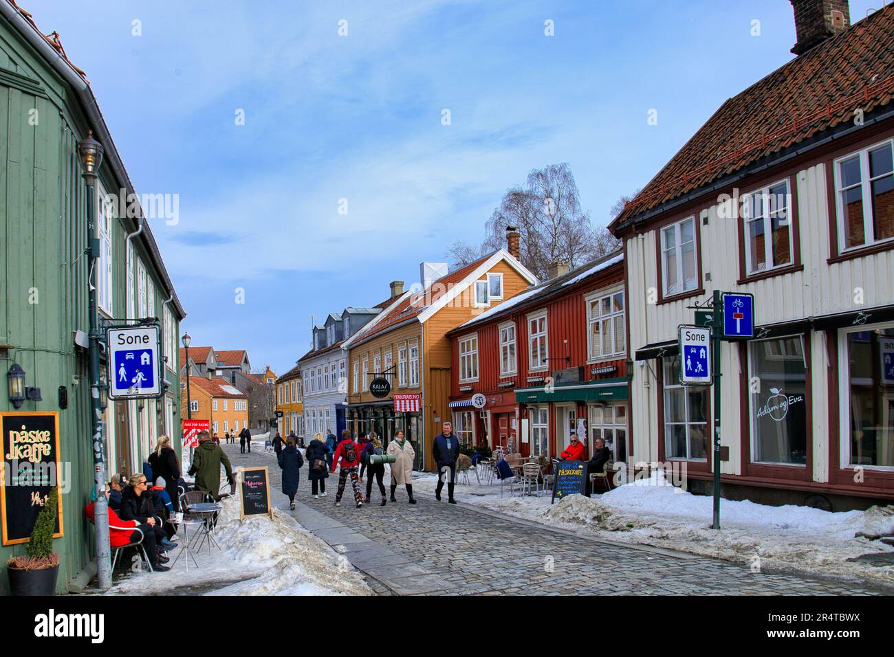In winter after snow tourists in trendy Bakklandet area of Trondheim ...