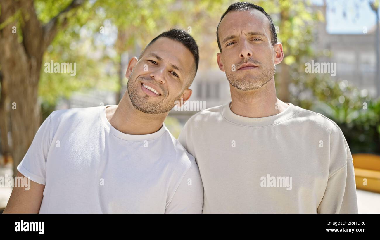 Two men couple smiling confident hugging each other at park Stock Photo ...