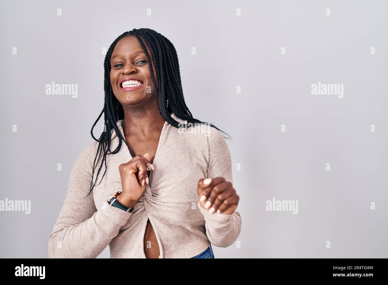African woman with braids standing over white background disgusted ...
