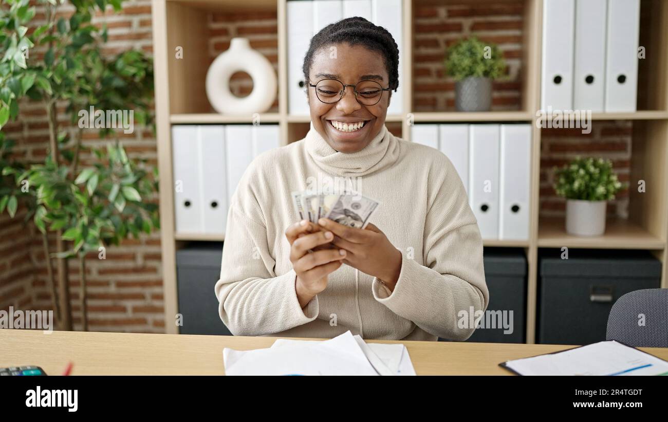 African american woman business worker counting dollars at office Stock ...