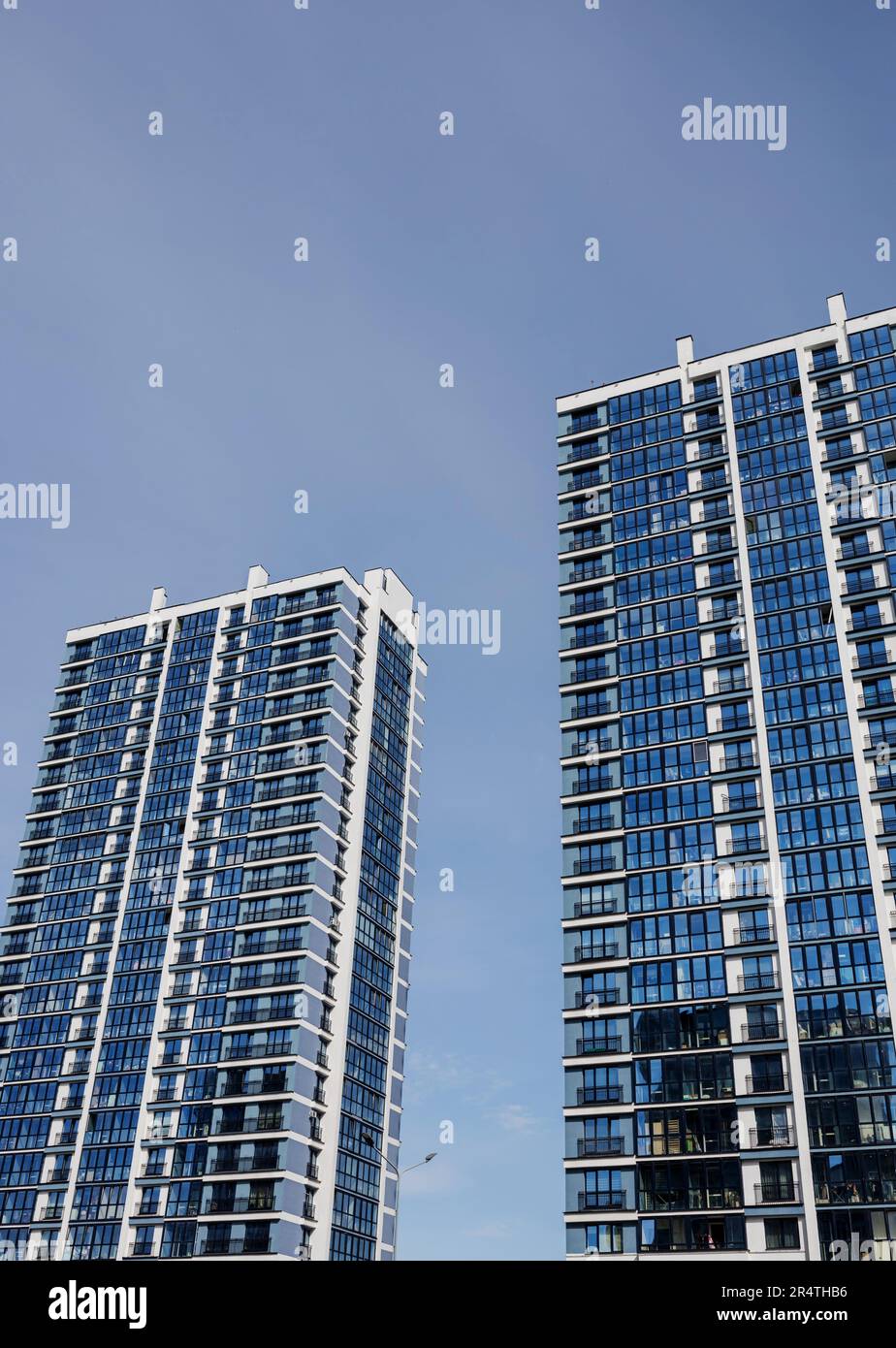 Modern apartments with blue sky background. High rise glass residential ...