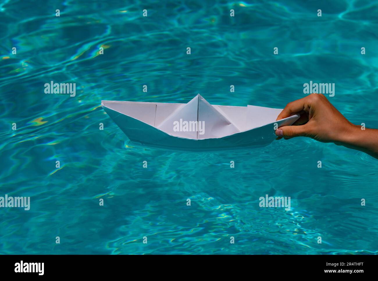 Paper ship and ocean water. Tourism and traveling, travel dreams ...