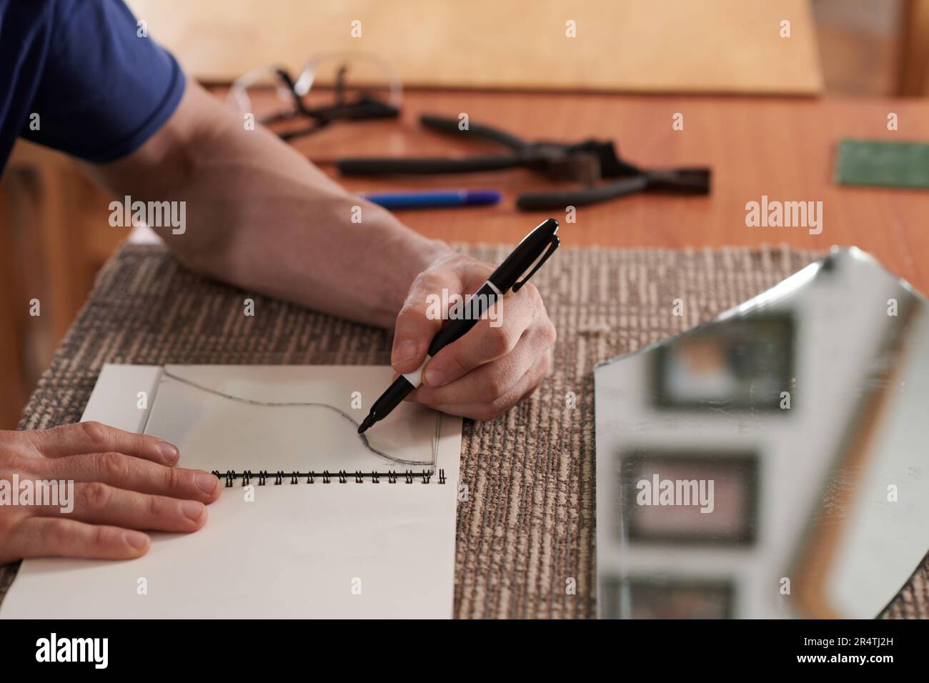 Left-handed craftsman drawing sketches for new glass project Stock ...