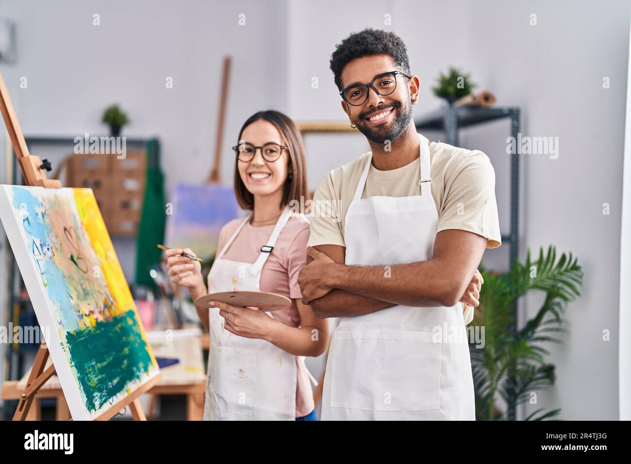 Man and woman artists smiling confident drawing at art studio Stock ...