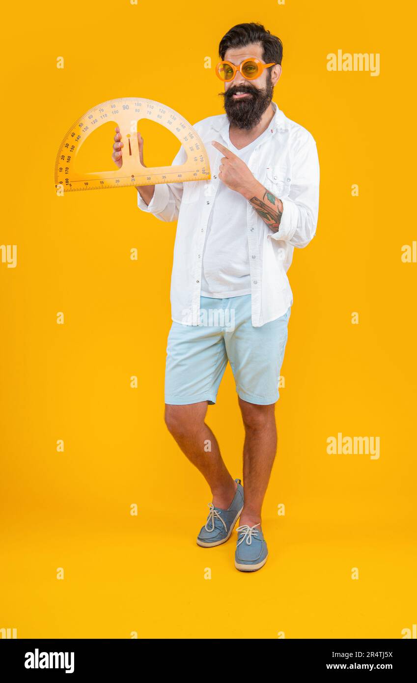 man hold geometry protractor on background, point finger. photo of man ...