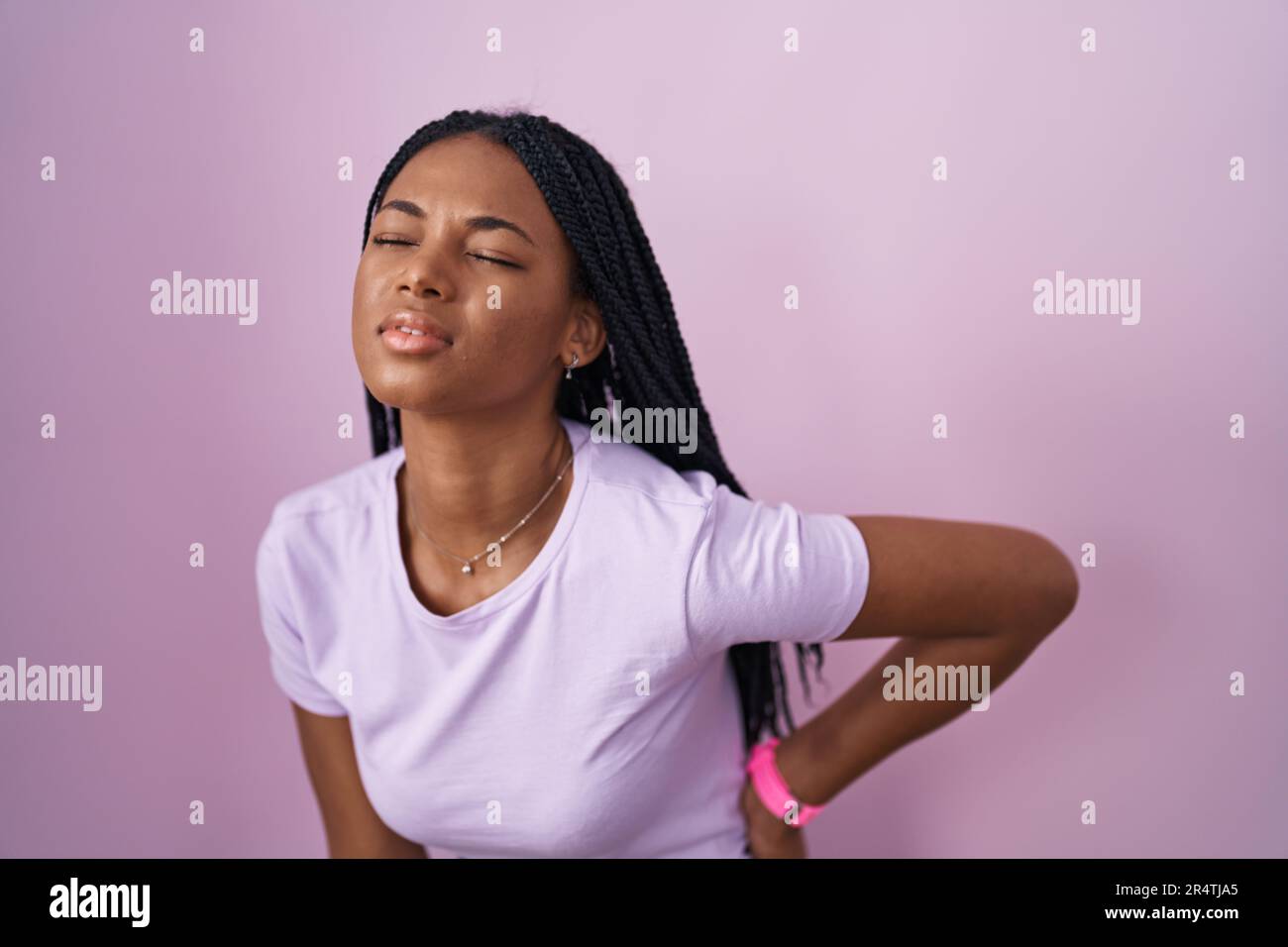 African american woman with braids standing over pink background ...