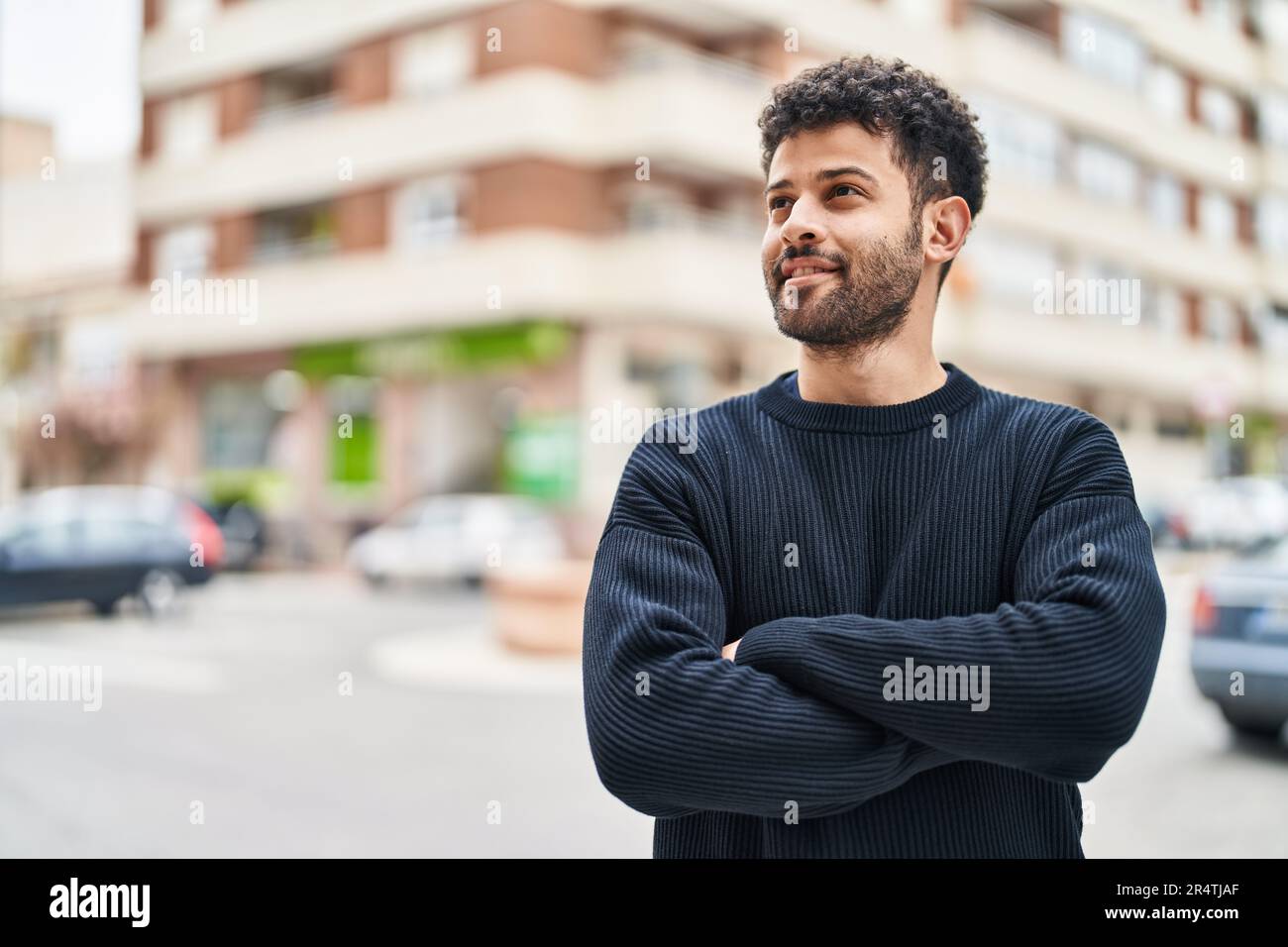 Young arab man smiling confident standing with arms crossed gesture at ...