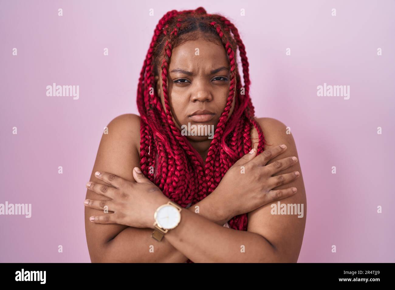 African american woman with braided hair standing over pink background ...