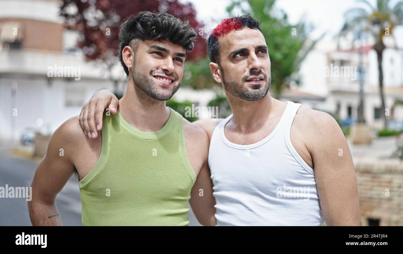 Two men couple smiling confident hugging each other at street Stock ...