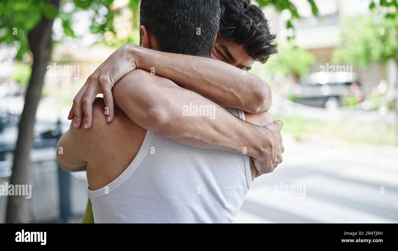 Two men couple hugging each other at park Stock Photo - Alamy