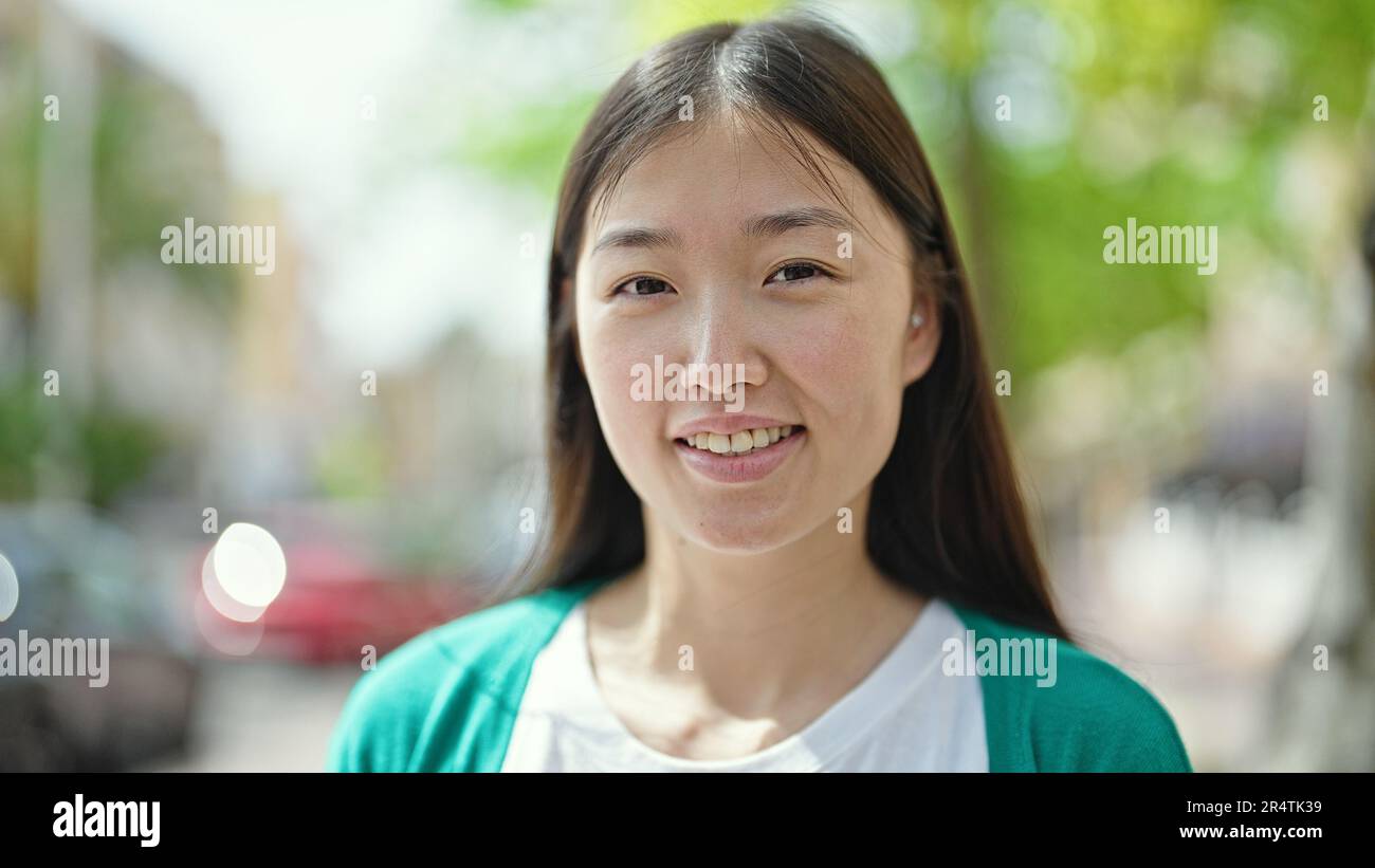 Young chinese woman smiling confident standing at street Stock Photo ...