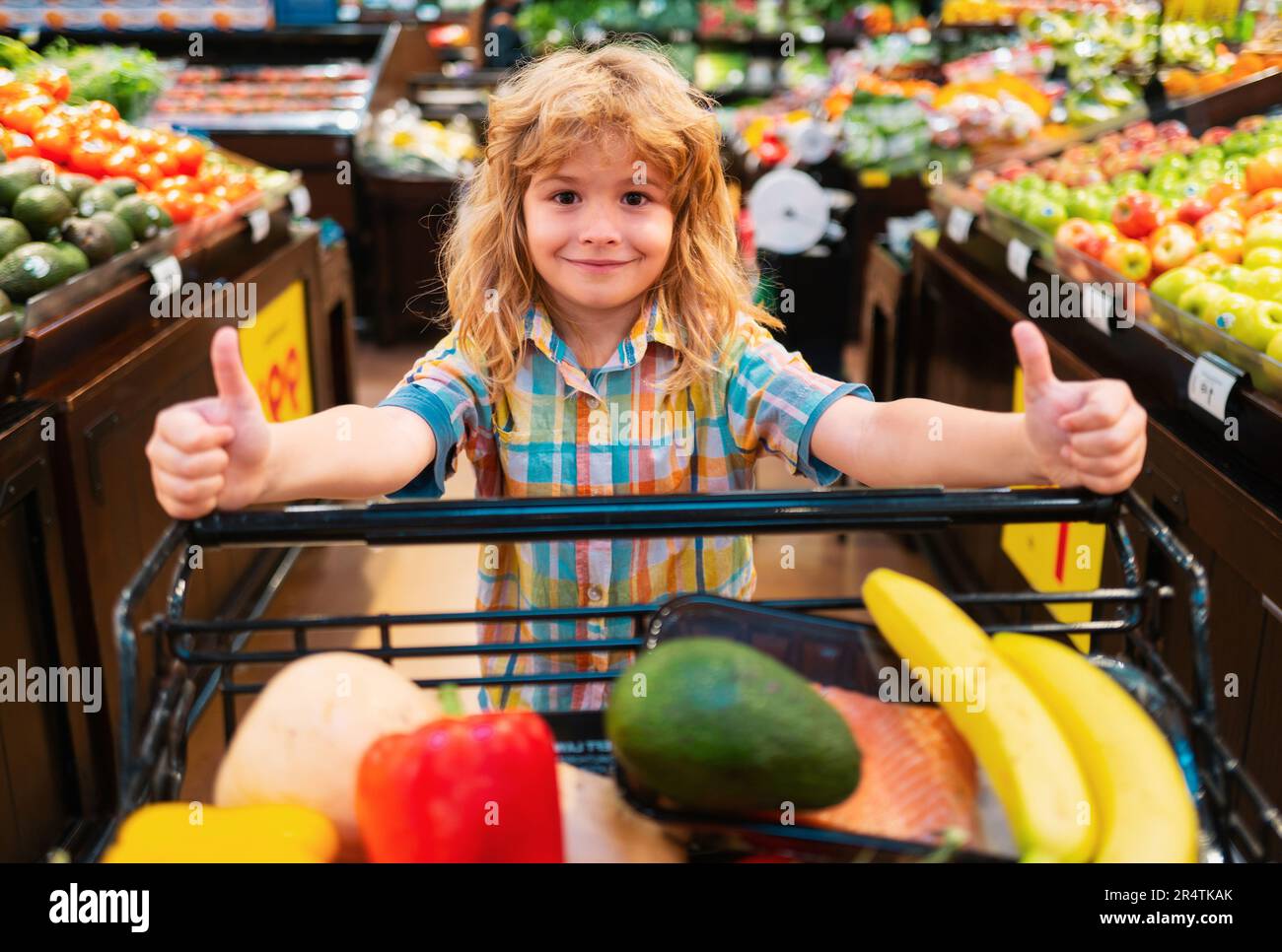 Child buying fruit in supermarket. Kid buy fresh vegetable in grocery ...