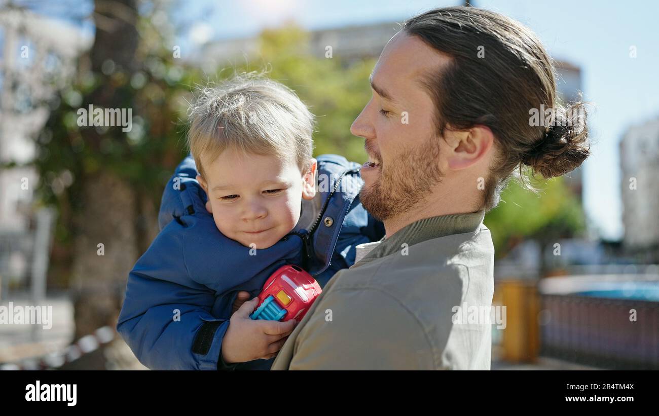 Father and son smiling confident hugging each other at park Stock Photo ...