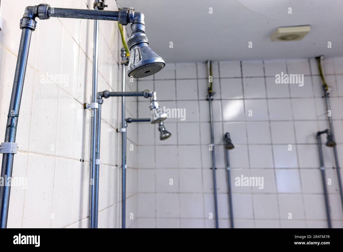 Showers at sports club Stock Photo - Alamy
