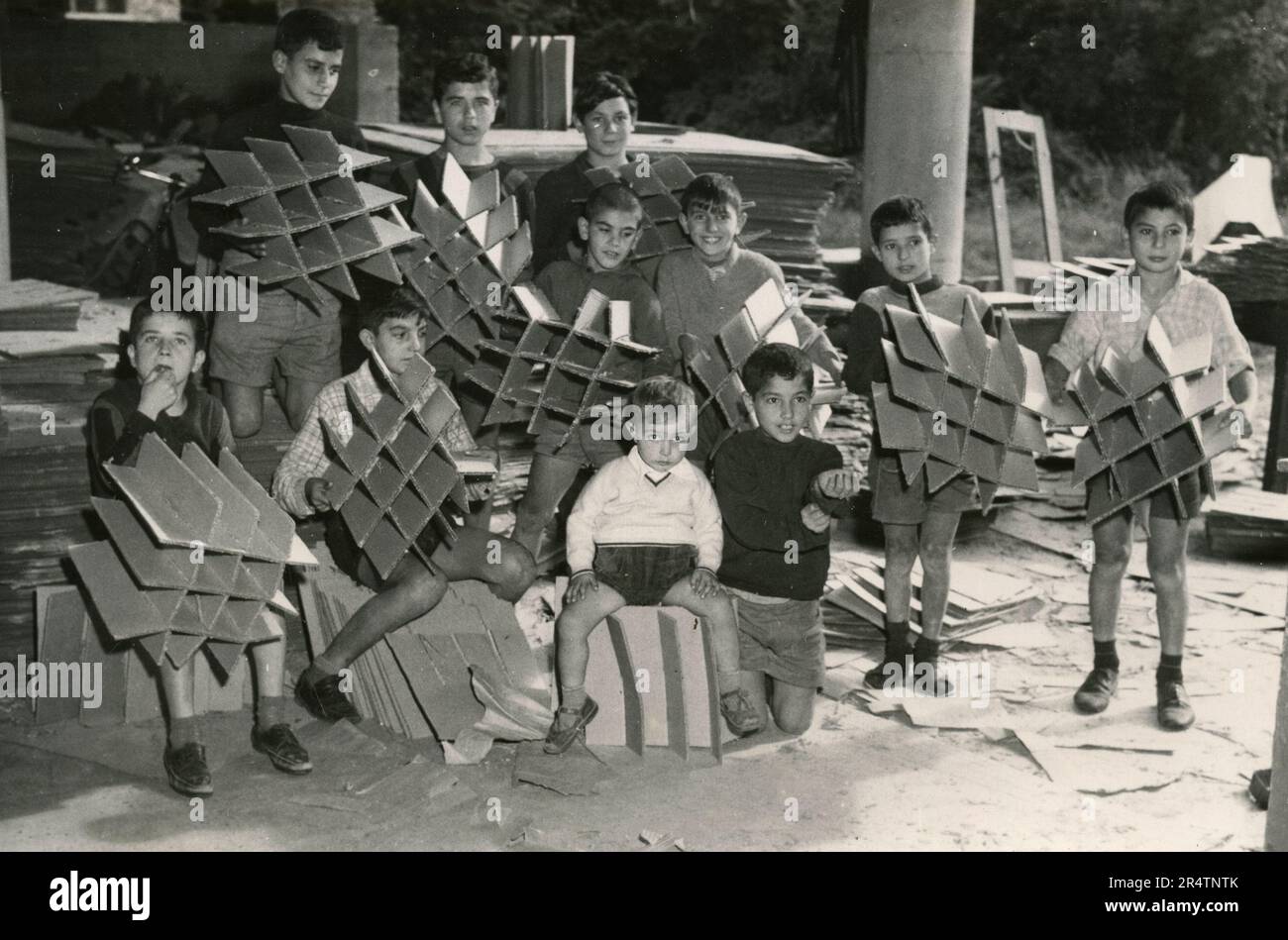 Group of children playing outside a cardboard factory, USA 1965 Stock ...