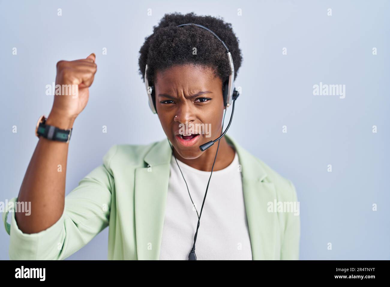 African american woman wearing call center agent headset angry and mad ...
