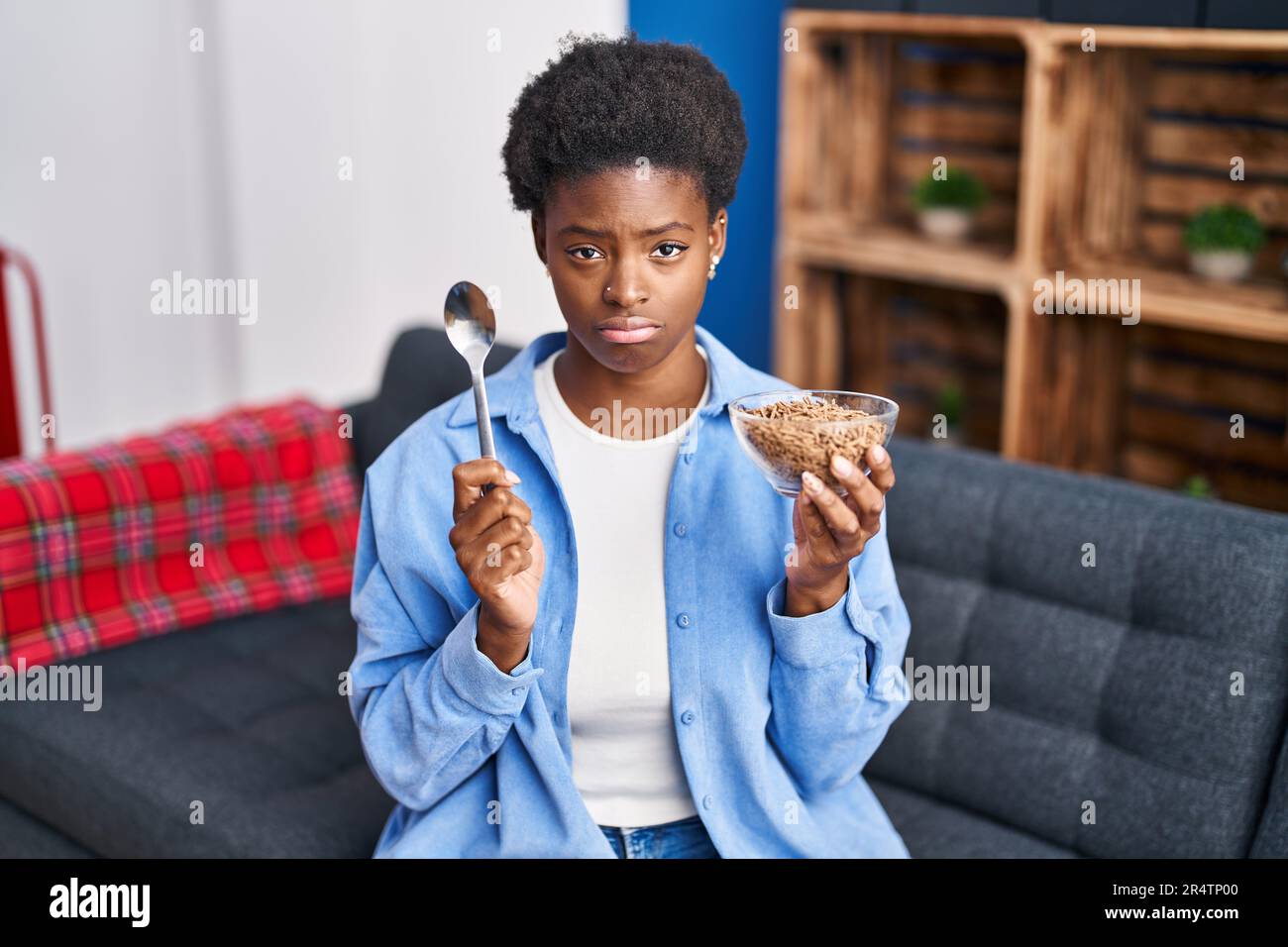 African american woman eating healthy whole grain cereals depressed and ...